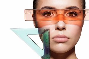 Measure the proportions of a beautiful female face with rulers before ...